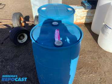 Repocast.com® | Two blue 55 gallon drums with two...
