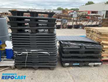Repocast.com® | (2) stacks of black plastic skids