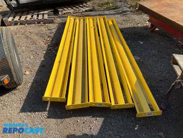 Repocast.com® | Five yellow guard rails roughly 10’ long.